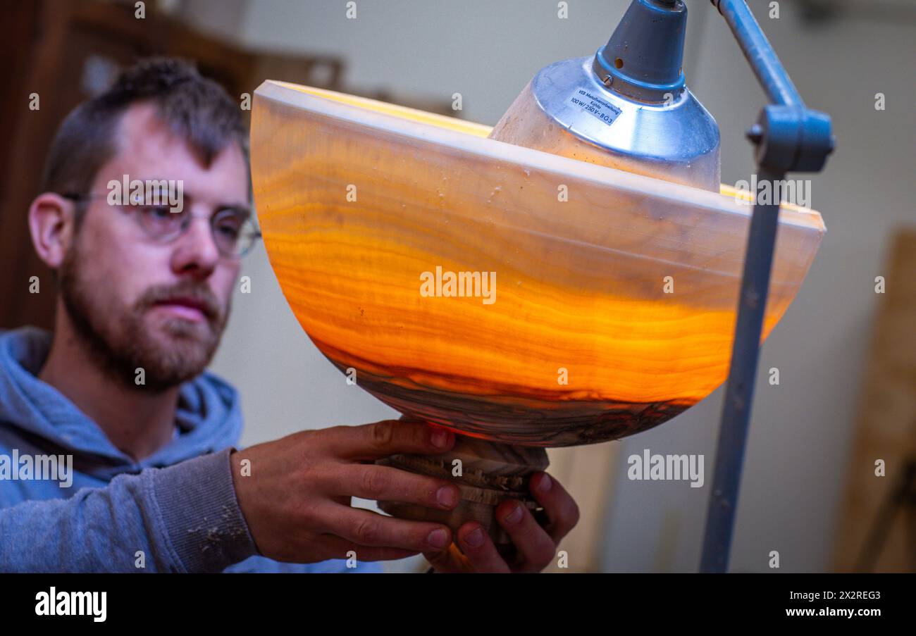 Wesenberg, Germany. 23rd Apr, 2024. Max Strack checks a translucent ...