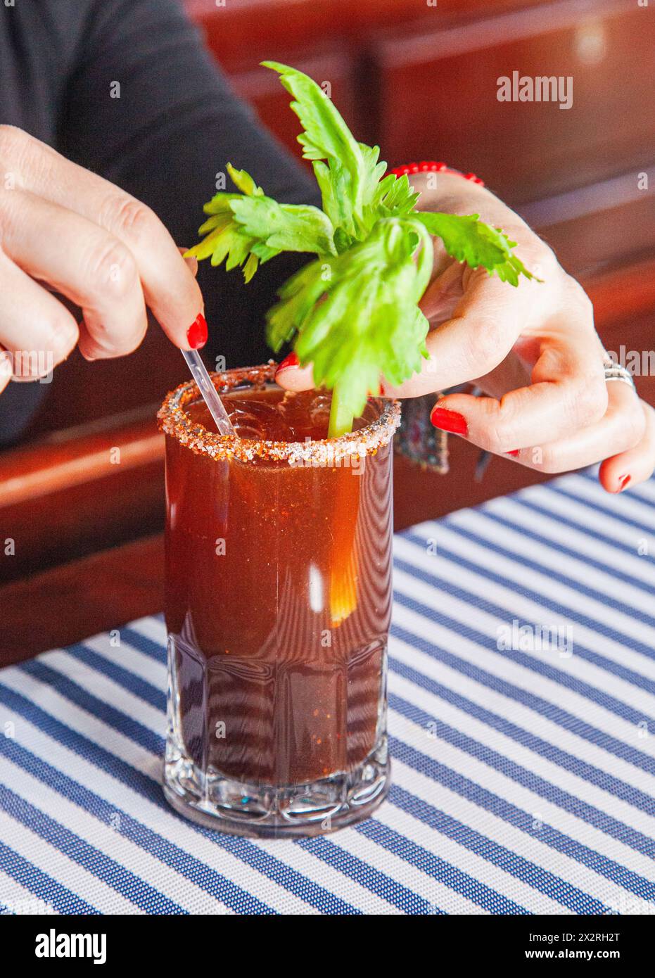 Preparing to taste a delicious bloody mary Stock Photo - Alamy