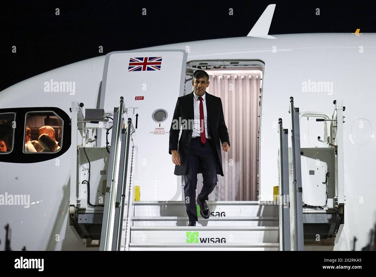 Prime Minister Rishi Sunak disembarks from the plane upon his arrival ...