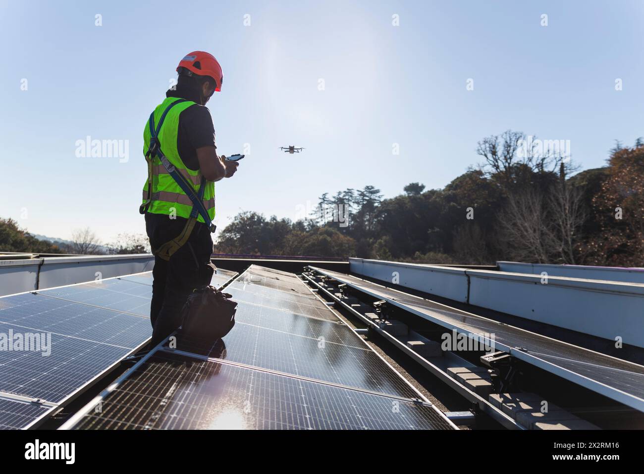 Mature engineer flying drone standing by solar panel Stock Photo - Alamy