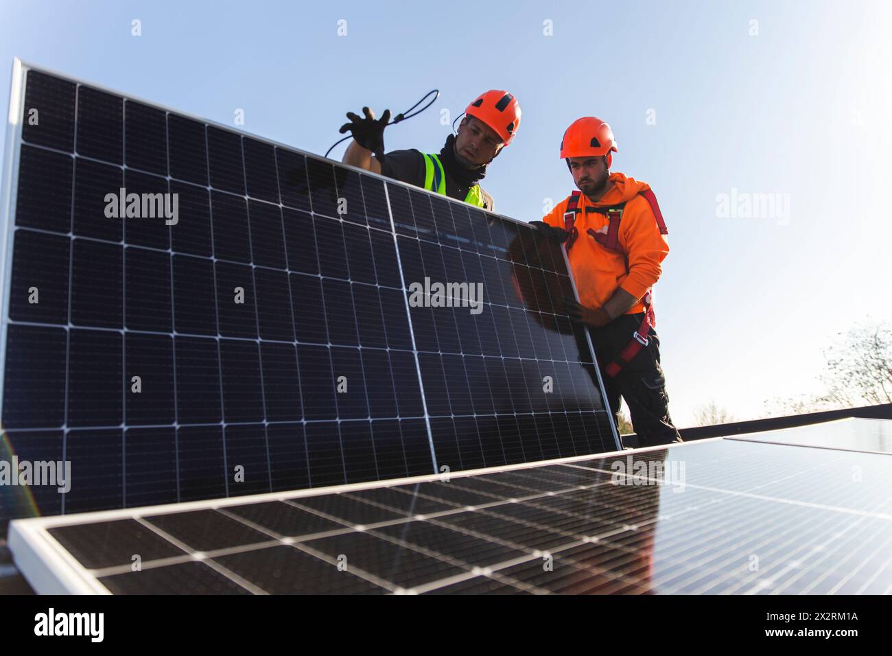 Coworkers with solar panel on rooftop Stock Photo - Alamy