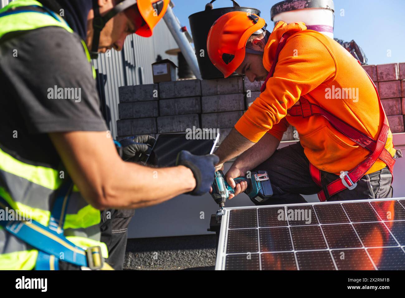 Coworkers installing solar panel on rooftop Stock Photo - Alamy