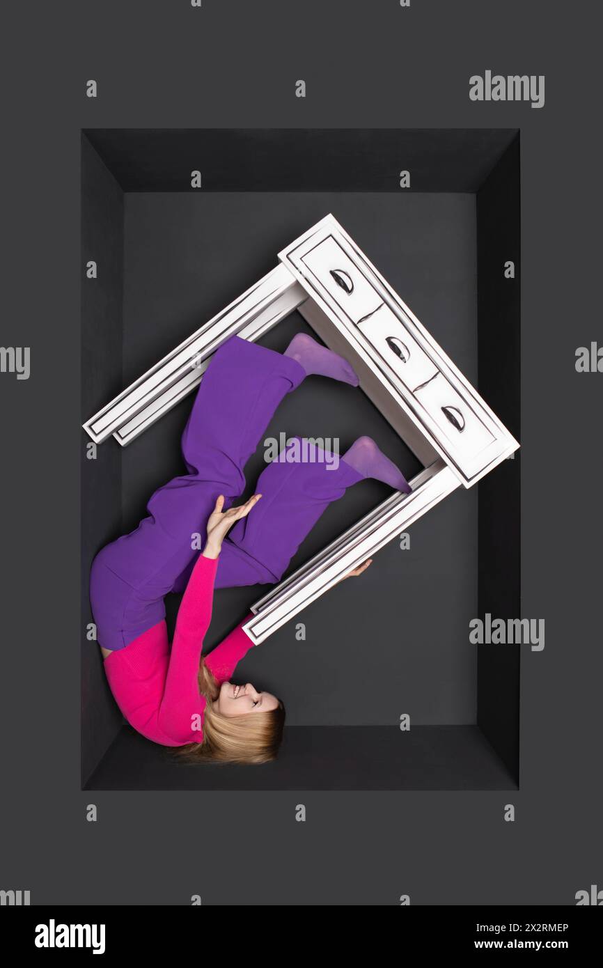 Teenage girl with table upside down in alcove Stock Photo - Alamy