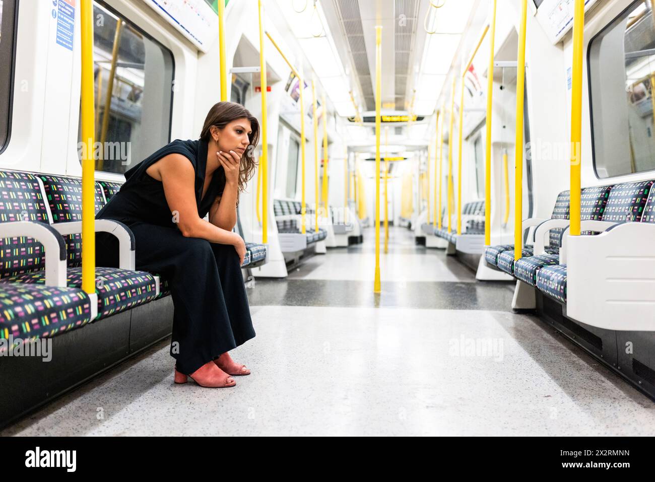 Sad woman sitting in subway train Stock Photo - Alamy