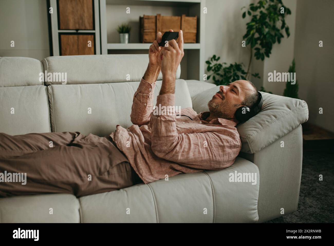 Male watching smartphone headphones hi-res stock photography and images ...