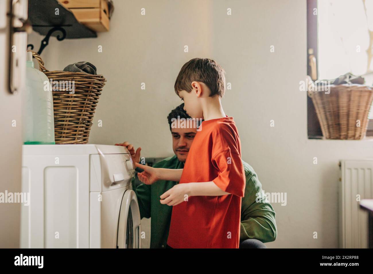 Father teaching son to operate washing machine at home Stock Photo - Alamy Father teaching son to operate washing machine at home Stock Photo - Alamy