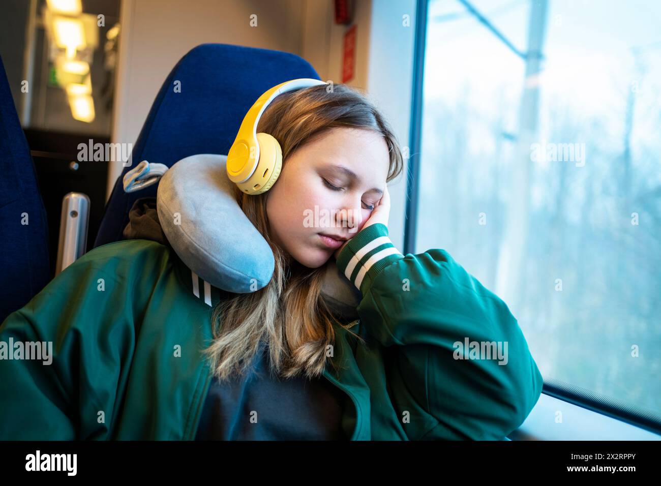 Tired blond girl napping in train Stock Photo - Alamy