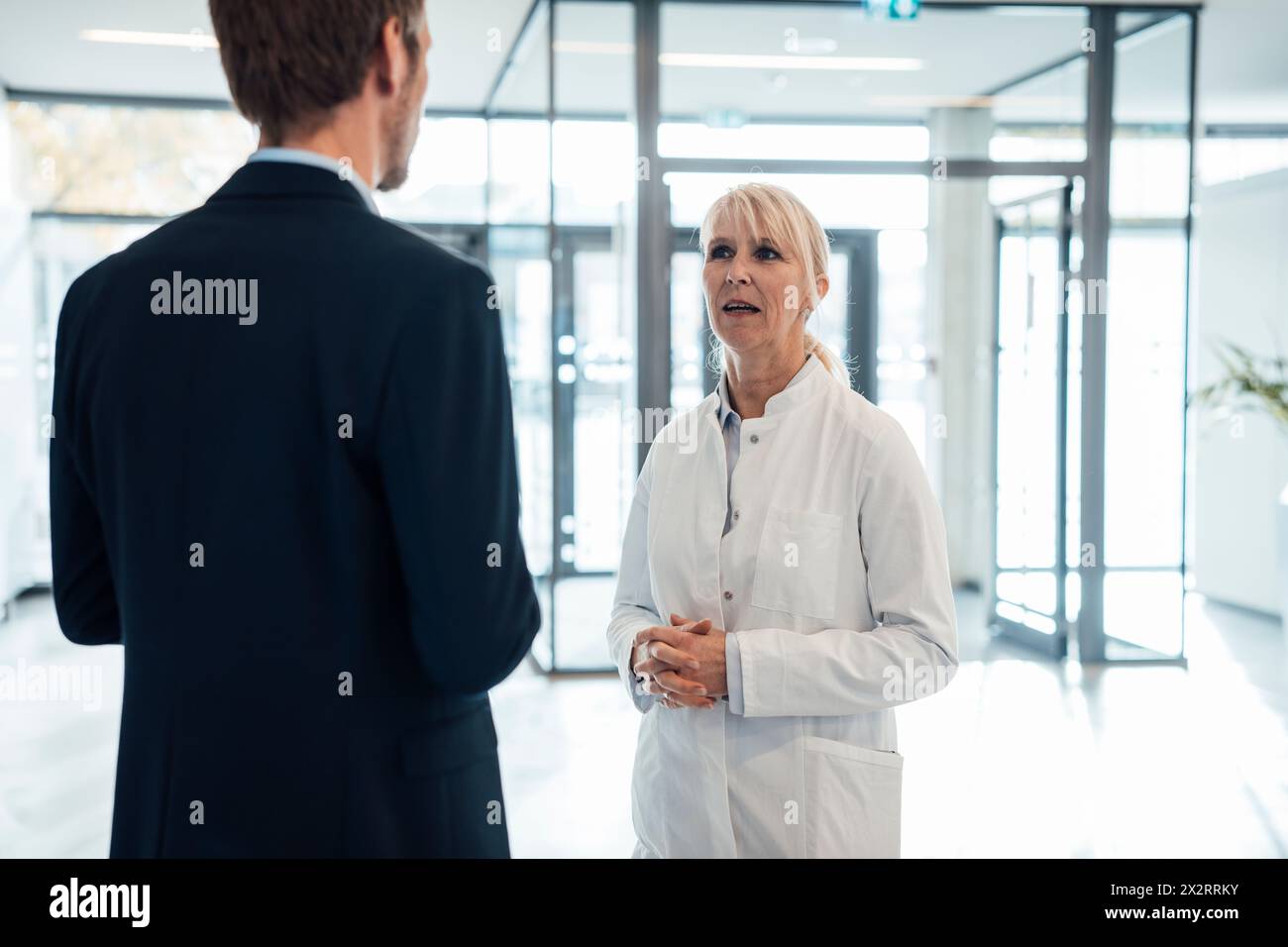 Doctor standing in hospital lobby hi-res stock photography and images ...