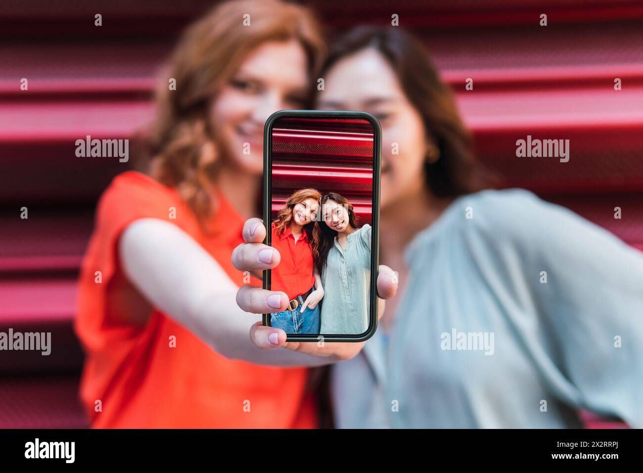 Friends talking selfie through smart phone near shutter Stock Photo - Alamy