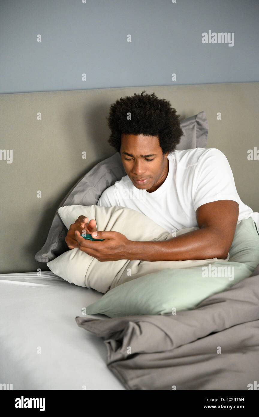 Man lying in bed mobile hi-res stock photography and images - Alamy