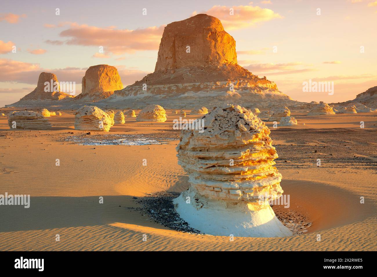 Limestone rock formations in white sand Sahara desert at sunset, Egypt ...