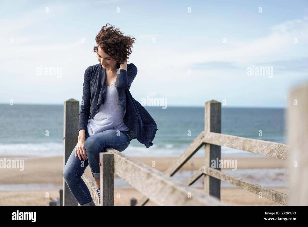 Woman sitting railing hi-res stock photography and images - Alamy