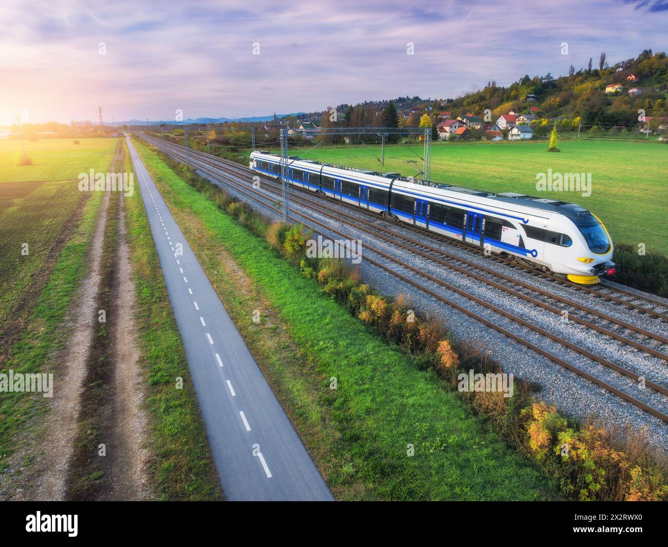 Aerial view of high speed train, mountains, green fields, road Stock ...