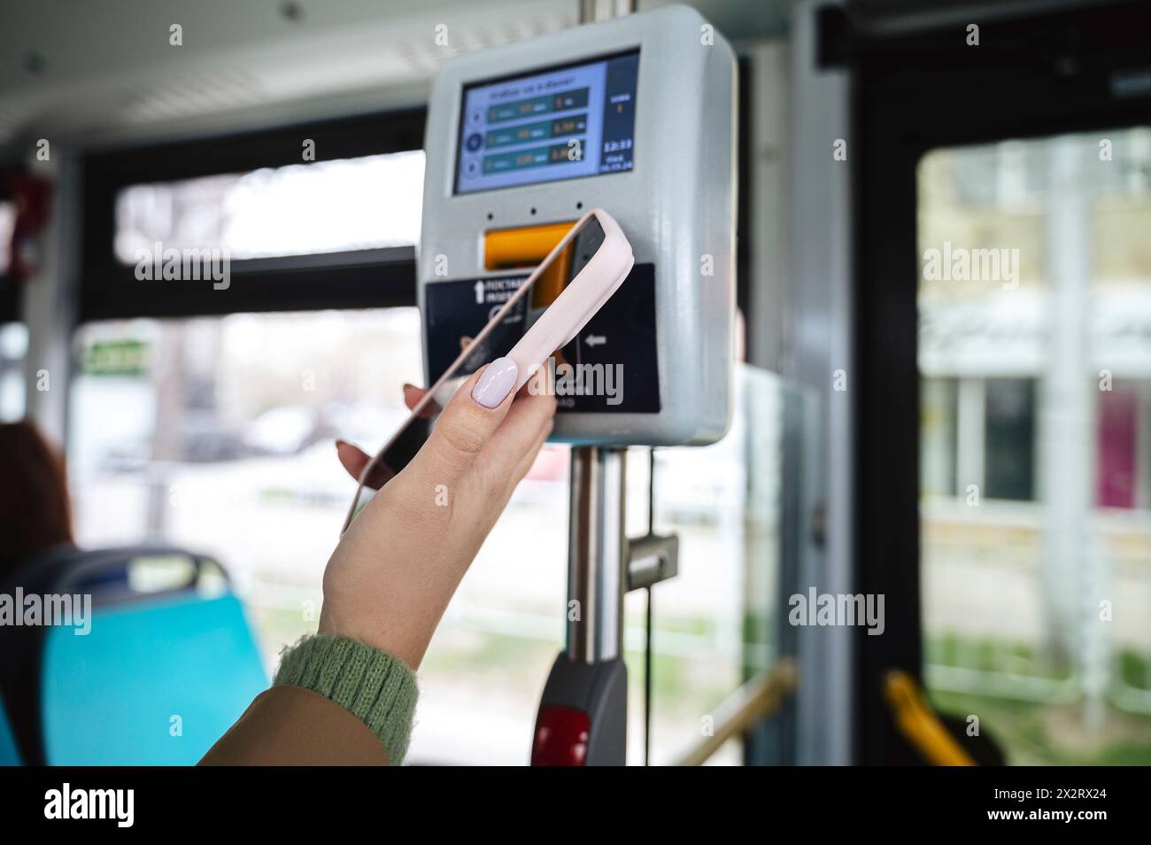 Hand of woman buying ticket in bus through smart phone Stock Photo - Alamy