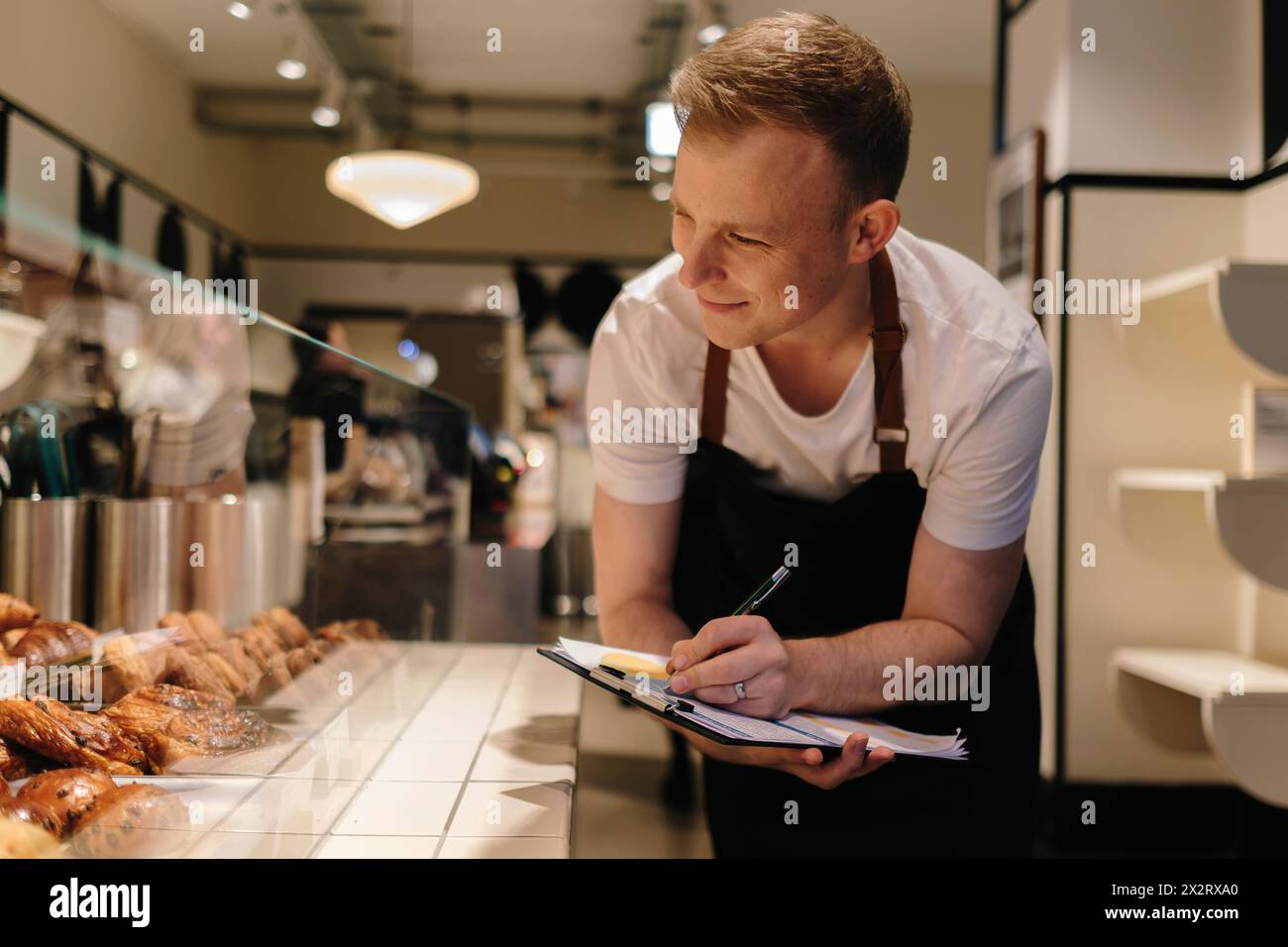 Smiling baker holding loaf bread hi-res stock photography and images ...