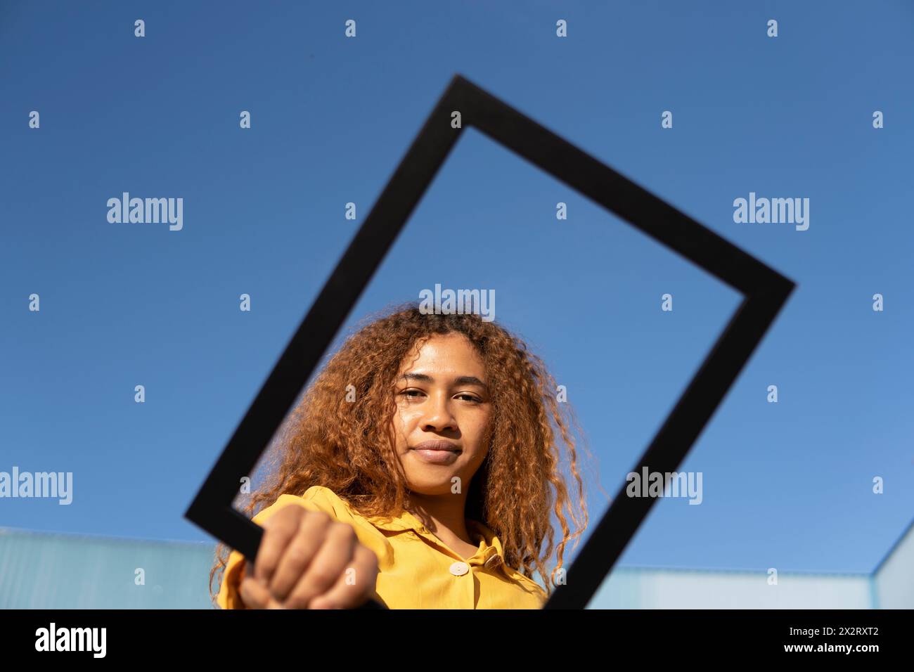 Woman looking at picture frame hi-res stock photography and images - Alamy