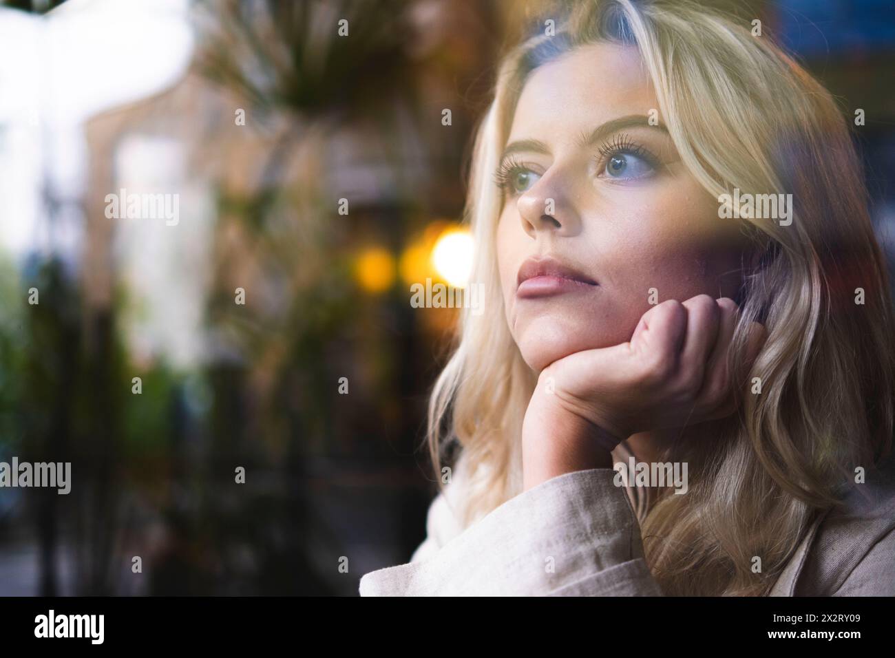 Through glass serious young hi-res stock photography and images - Alamy