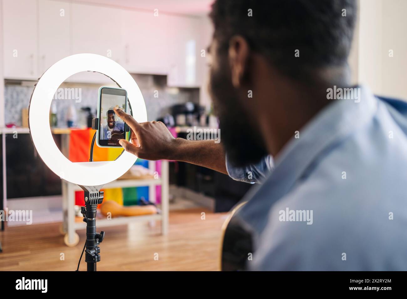 Influencer using smart phone on ring light at home Stock Photo - Alamy