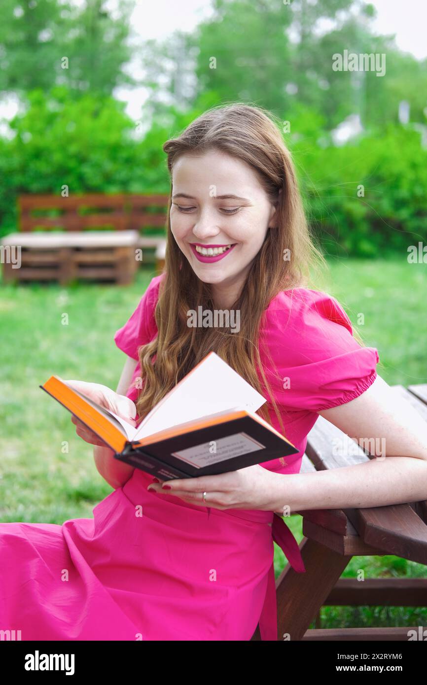 Beautiful woman enjoying book outdoors hi-res stock photography and ...