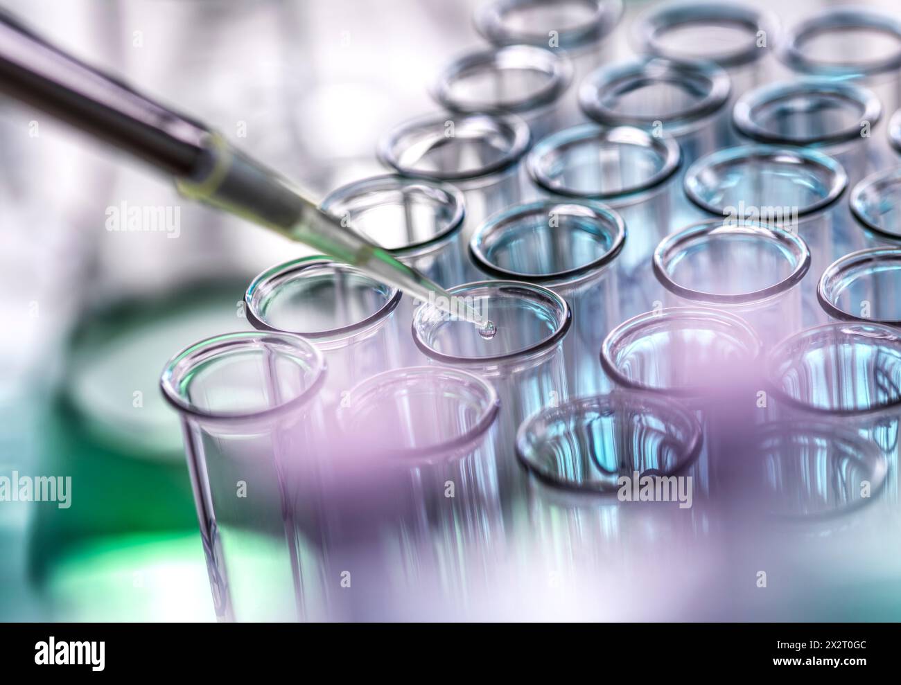 Scientist pipetting sample in test tubes at lab Stock Photo - Alamy