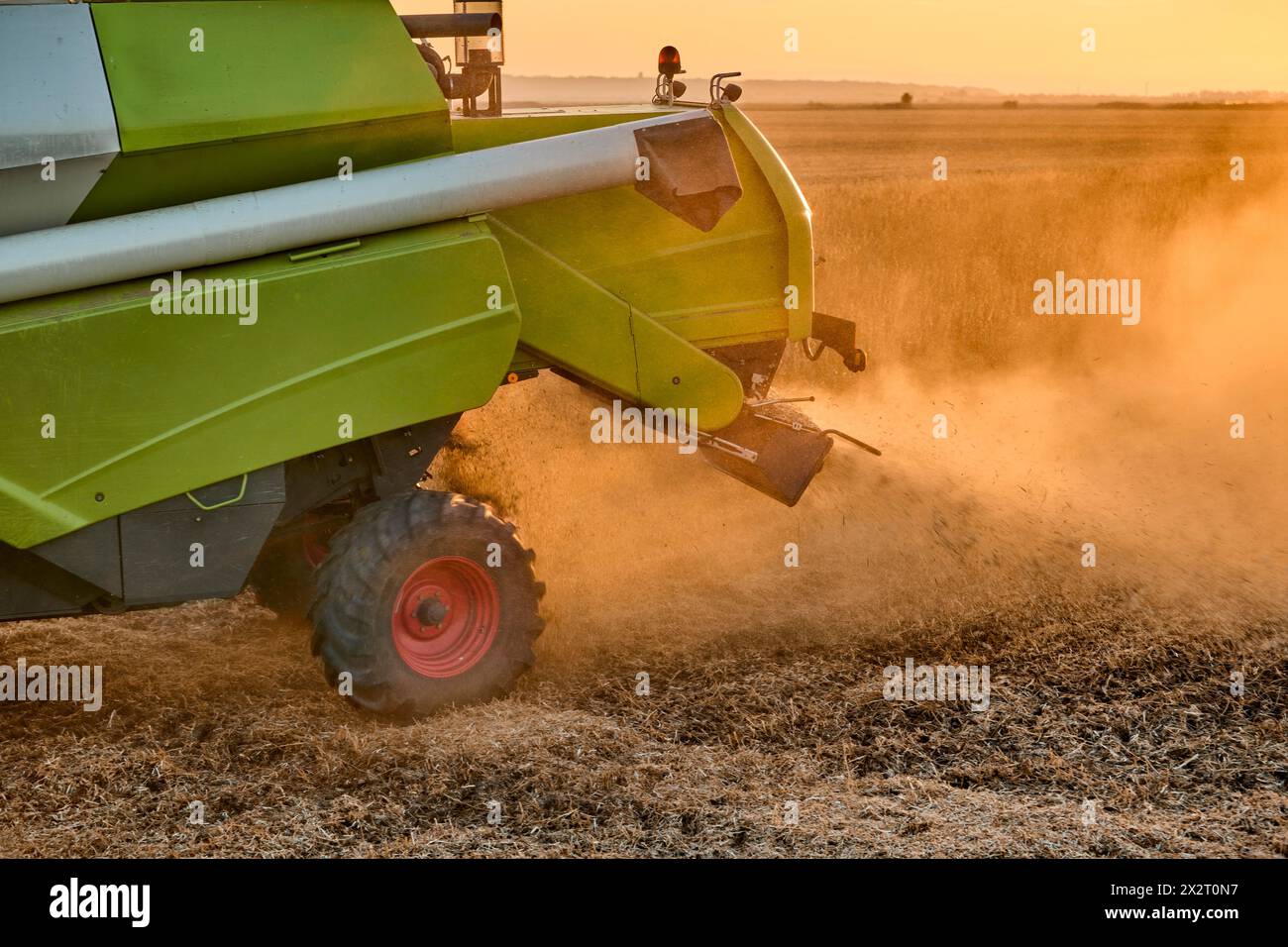 Combine harvester harvesting crops in field Stock Photo - Alamy