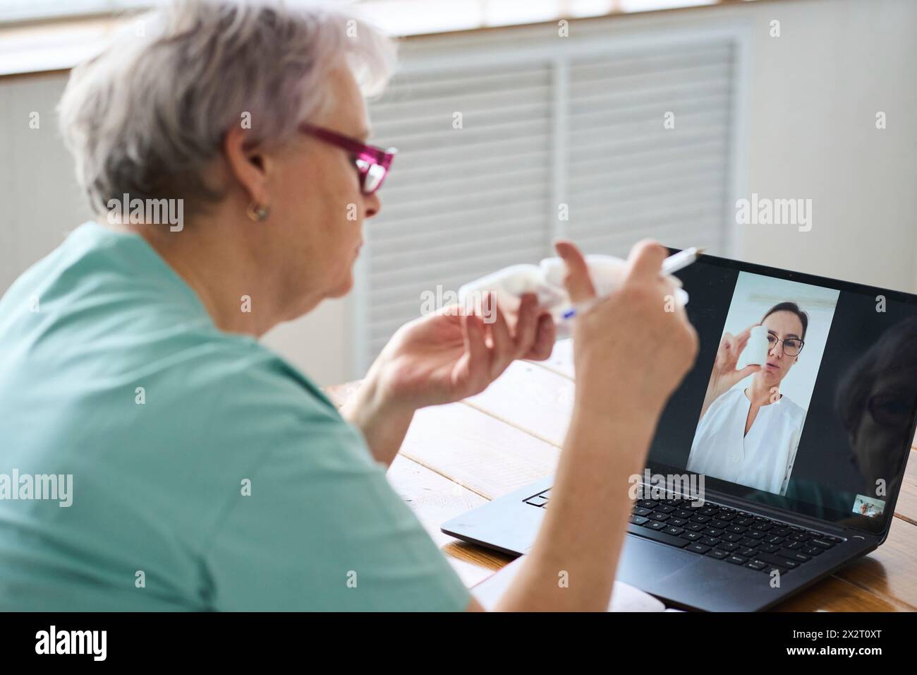 Senior female doctor doing video hi-res stock photography and images ...