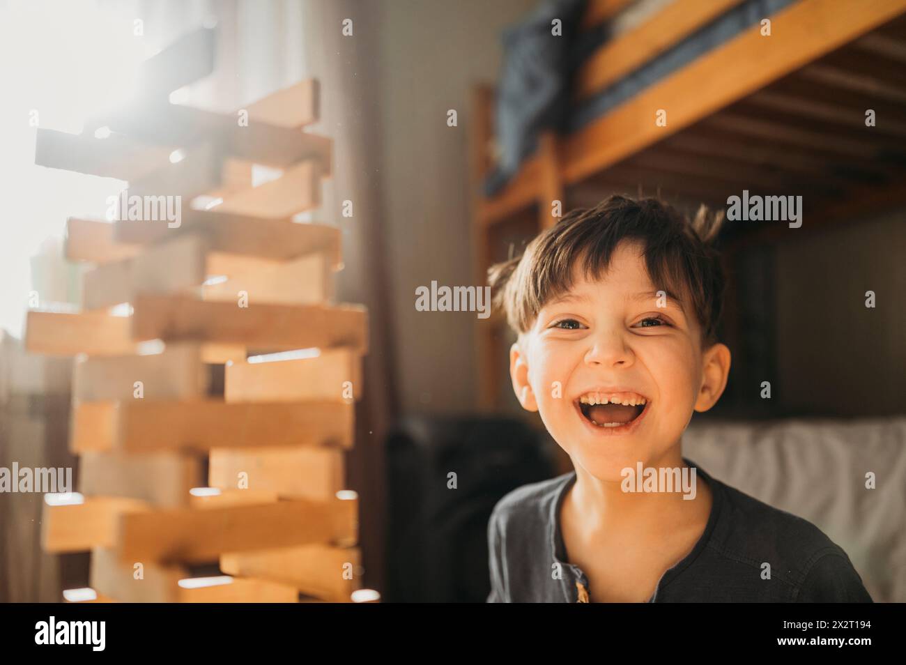 Cheerful boy near block removal tower at home Stock Photo - Alamy