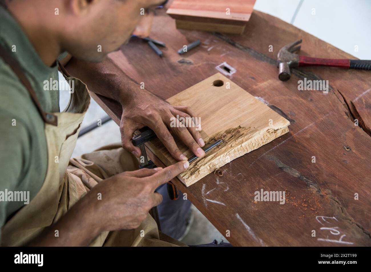 Carpenter carving on timber using chisel at workshop Stock Photo - Alamy