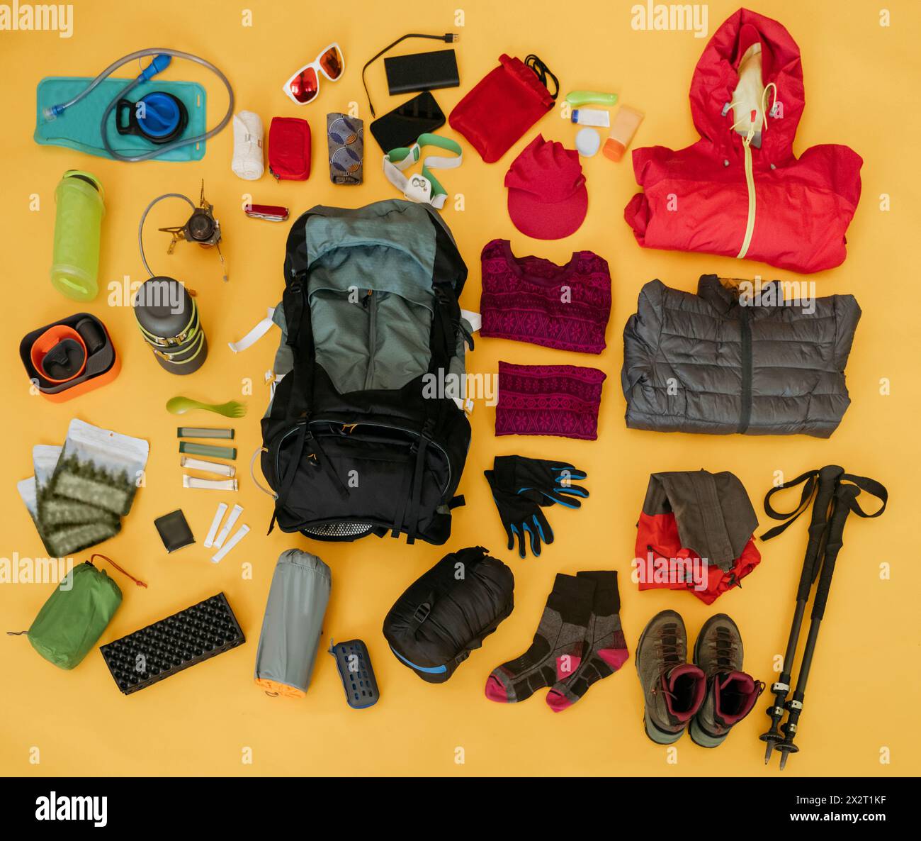 Hiking travel kit arranged on yellow background Stock Photo - Alamy