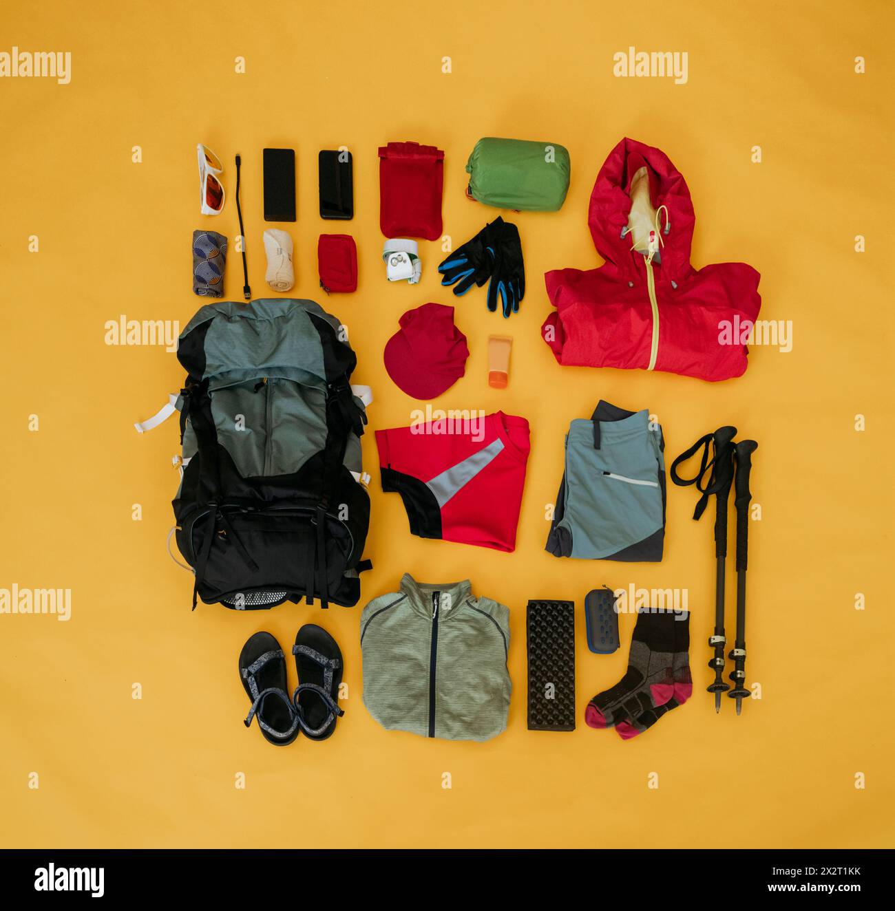 Travel kit for hiking organized on yellow background Stock Photo - Alamy