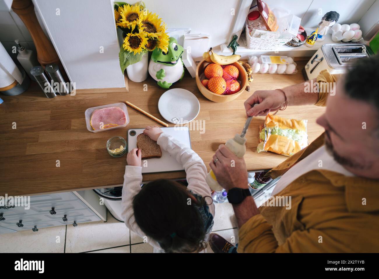 Father and daughter preparing sandwich at home Stock Photo - Alamy