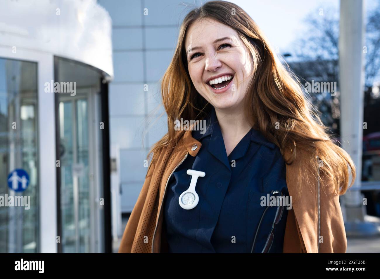 Happy young doctor standing near hospital building Stock Photo - Alamy