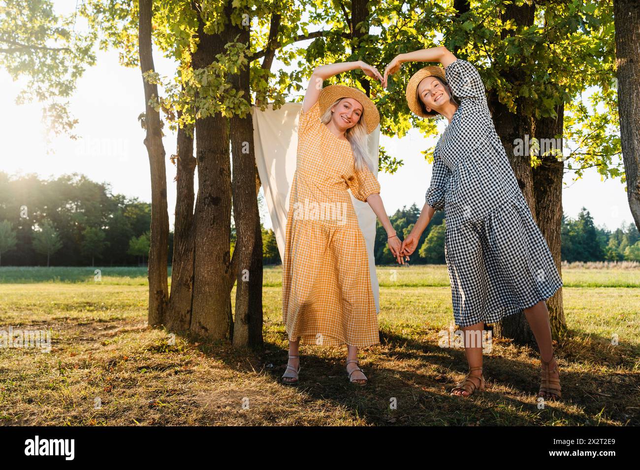 Women friends making heart hands hi-res stock photography and images ...