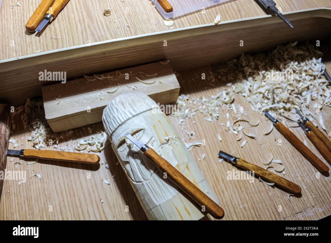 The process of wood carving. Carved old man or pagan deity Stock Photo ...