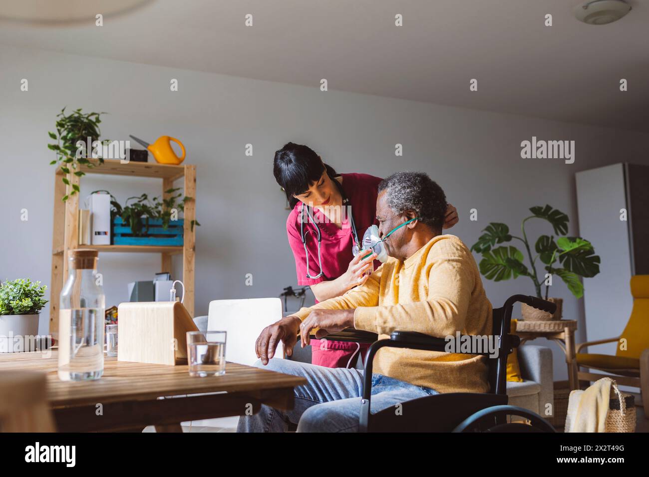 Home caregiver putting oxygen mask on senior man sitting in wheelchair Stock Photo - Alamy