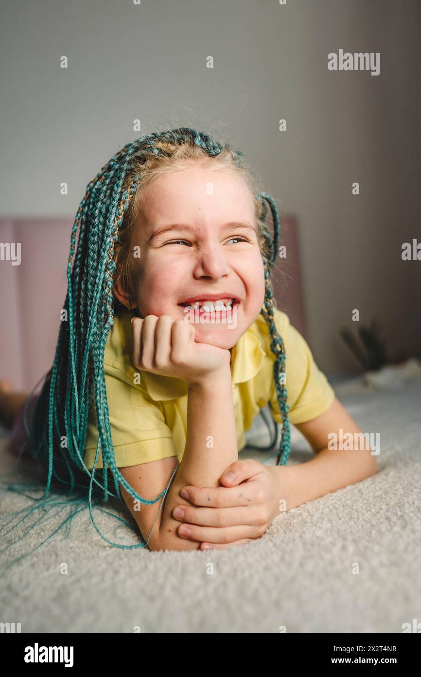 Cheerful girl lying on bed hi-res stock photography and images - Alamy