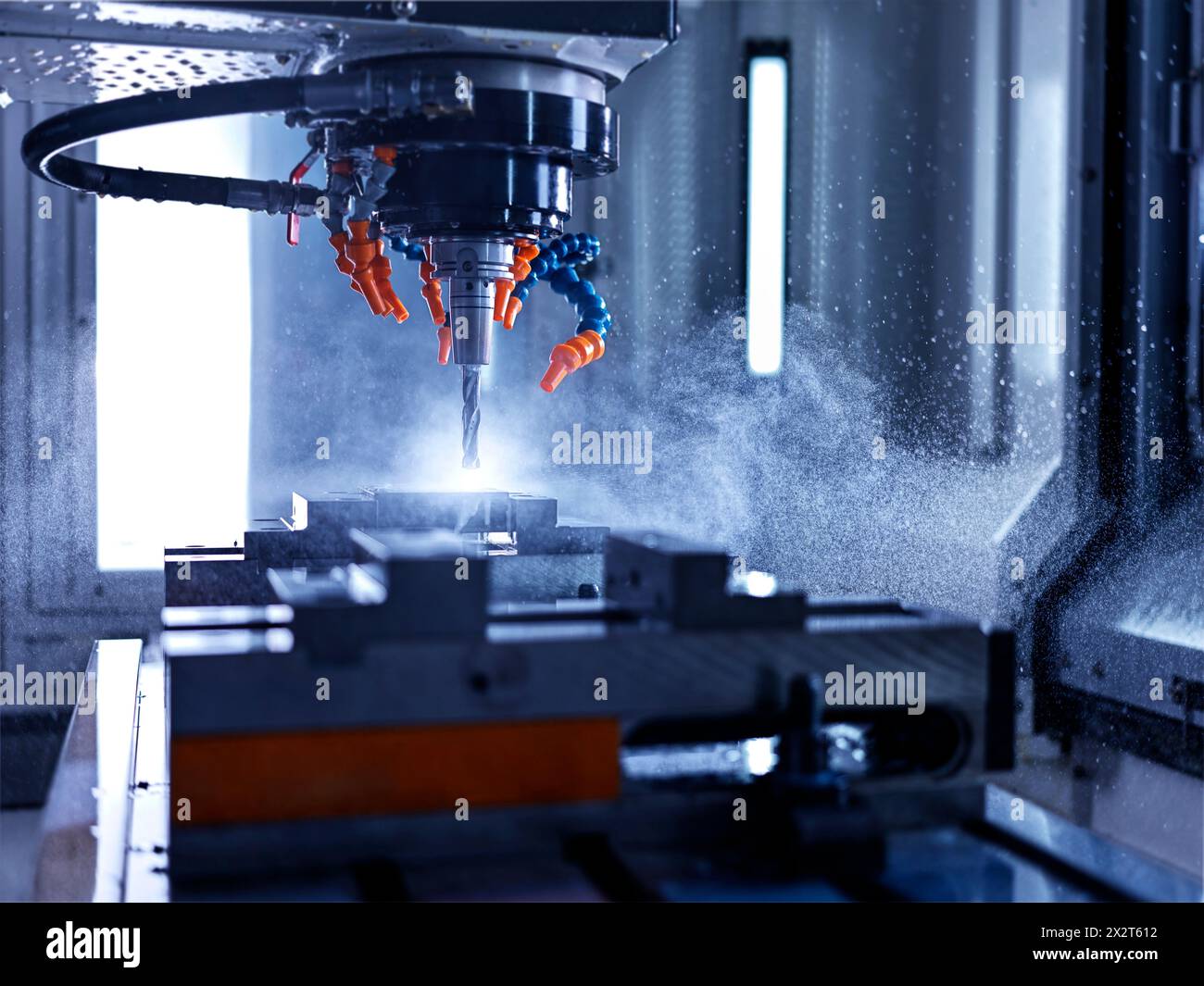 Computerized machine drilling metal object at factory Stock Photo - Alamy