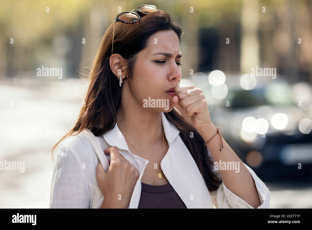 Young woman with allergy coughing at street Stock Photo - Alamy