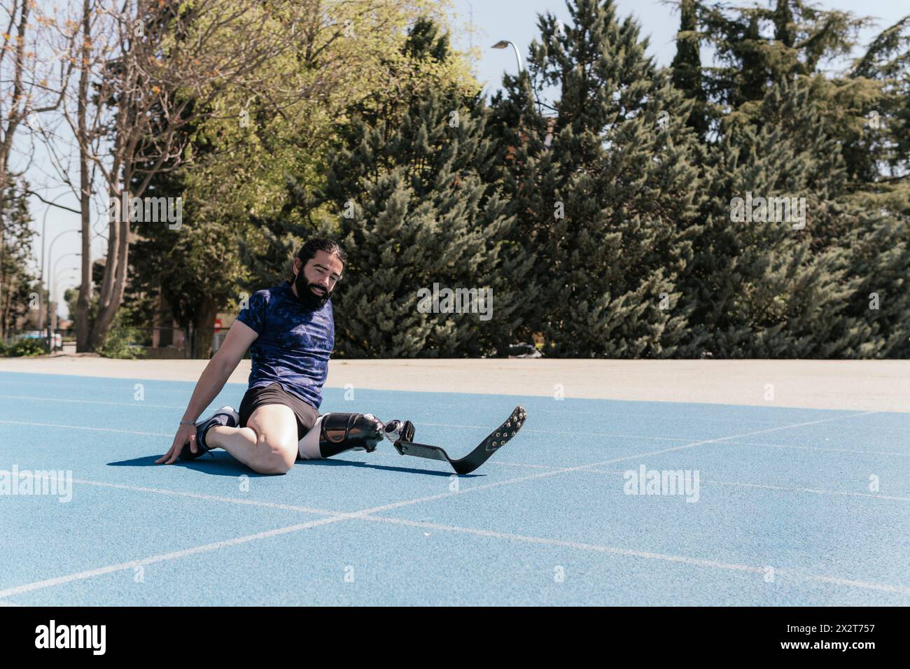 Athlete with prosthetic leg stretching on sports track Stock Photo - Alamy