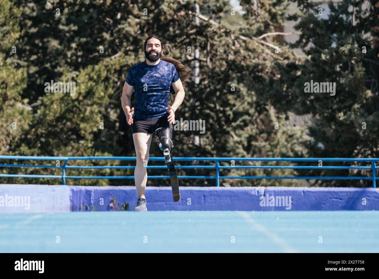 Athlete with prosthetic leg running on sports track Stock Photo - Alamy