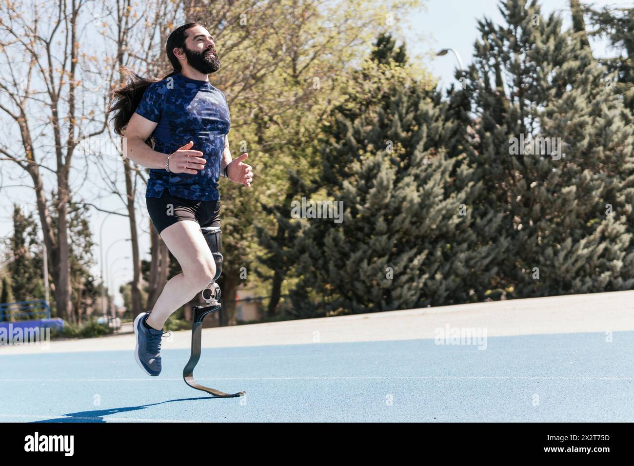 Athlete with prosthetic leg jogging on on track Stock Photo - Alamy