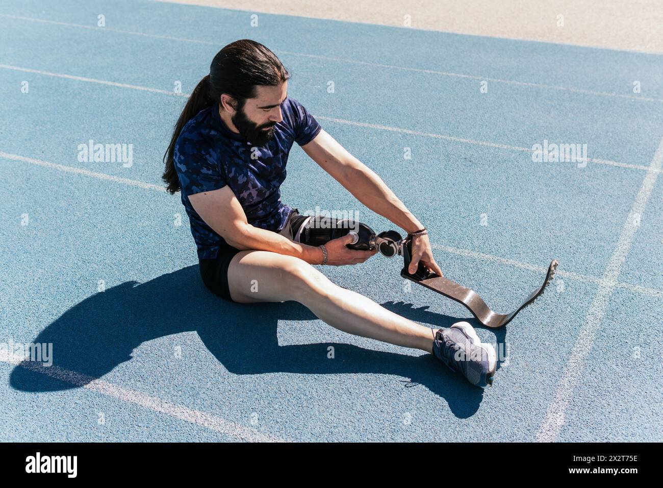 Athlete with prosthetic leg sitting on sports track Stock Photo - Alamy
