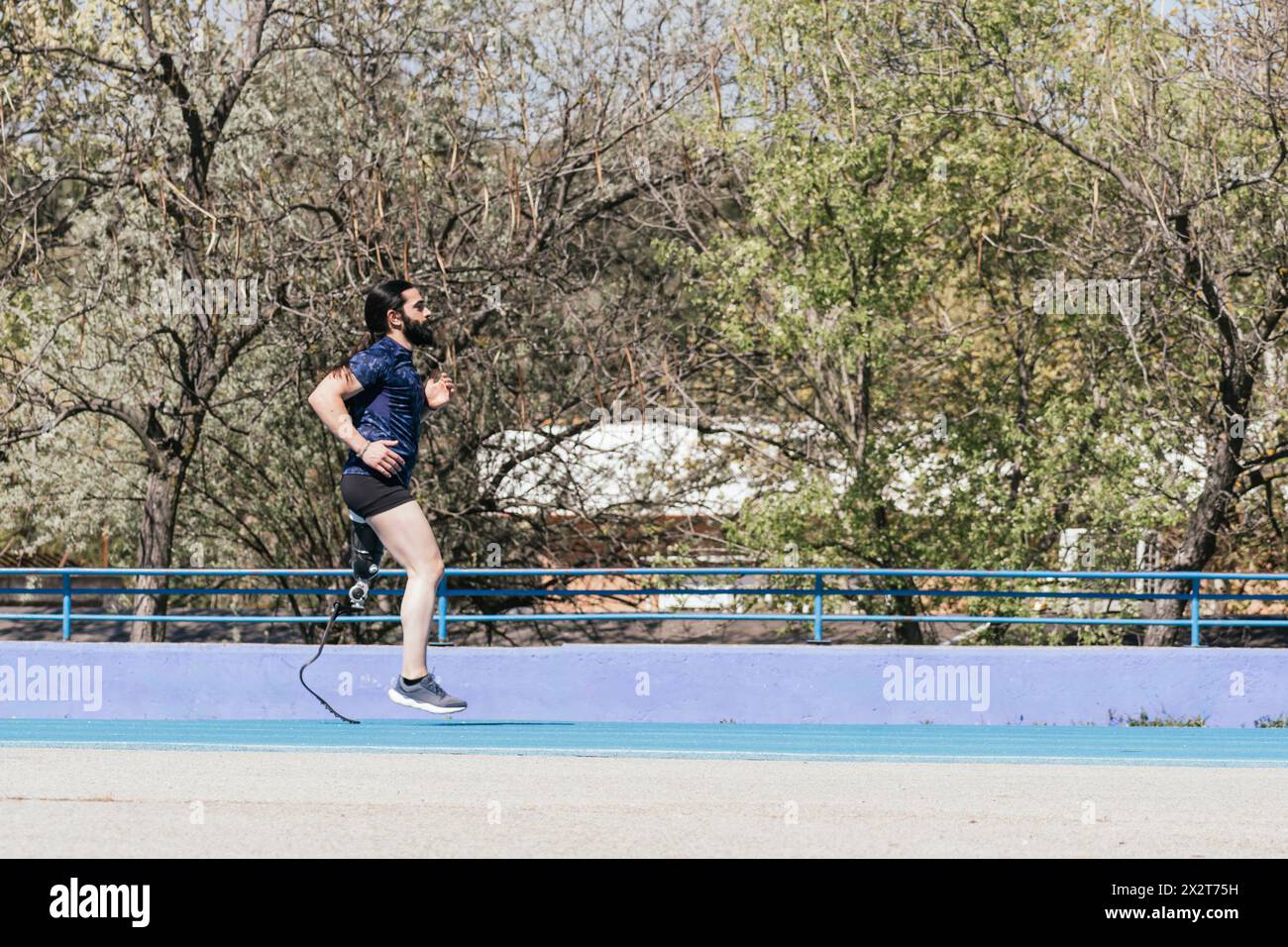 Athlete with artificial leg running on sports track Stock Photo - Alamy