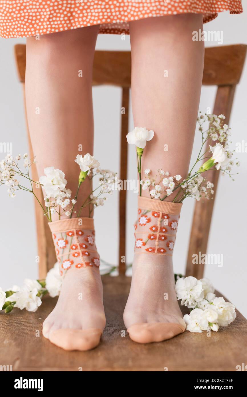 Woman standing leg on chair hi-res stock photography and images - Alamy