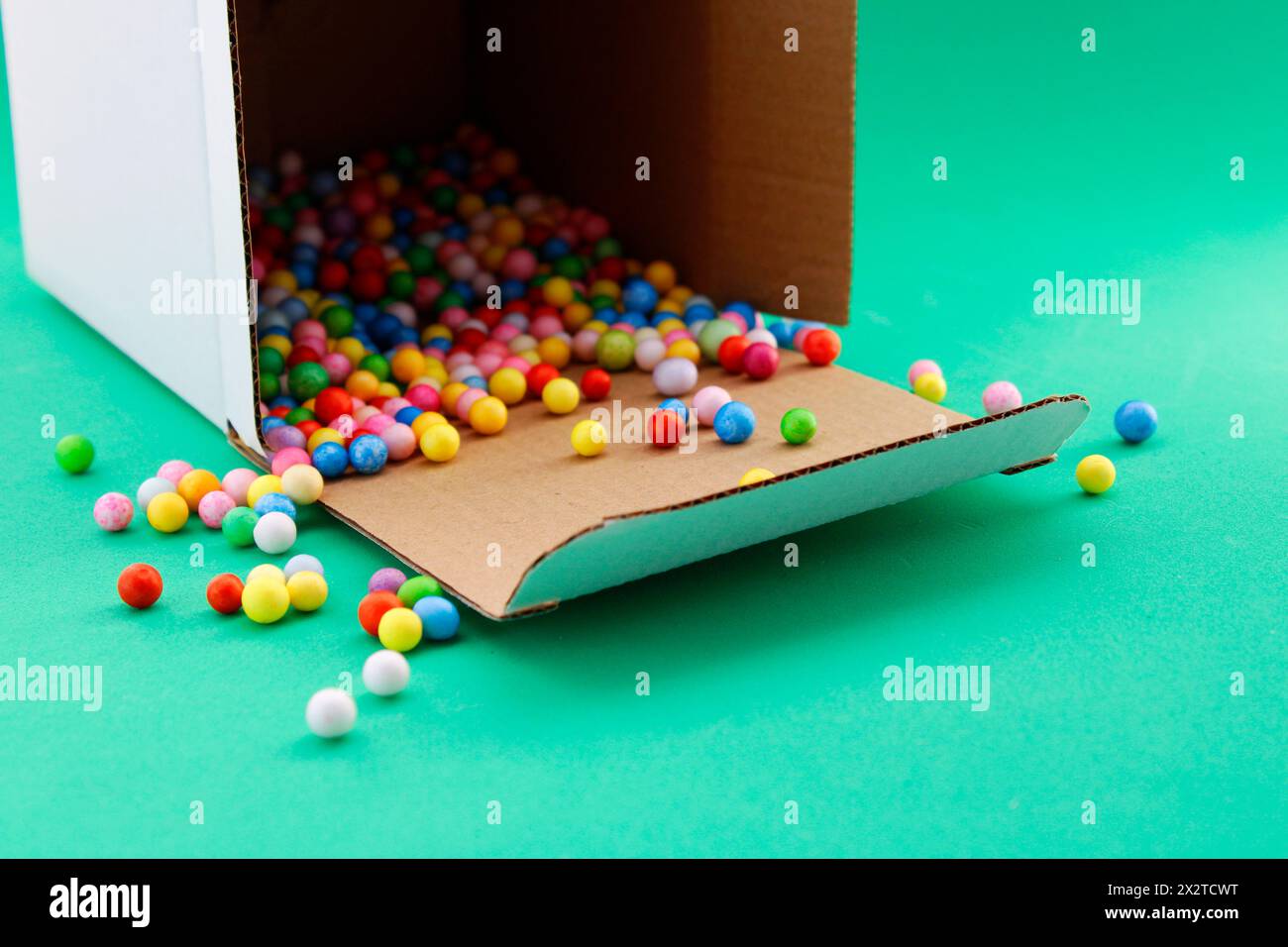 Packaging box with colorful spheres coming out of it Stock Photo - Alamy