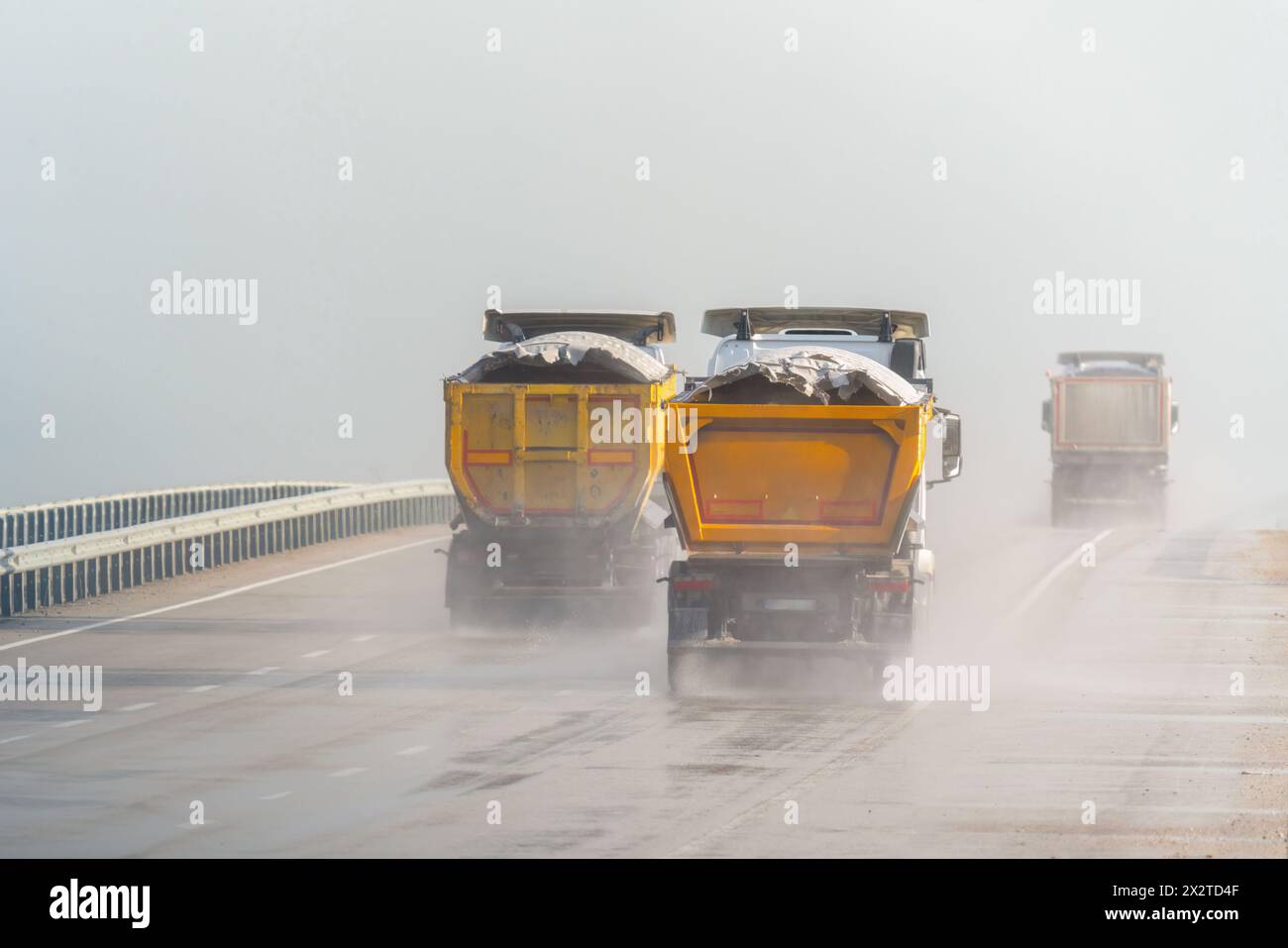 Sand lorries driving on motorway in the rain. Motorway in the rain ...