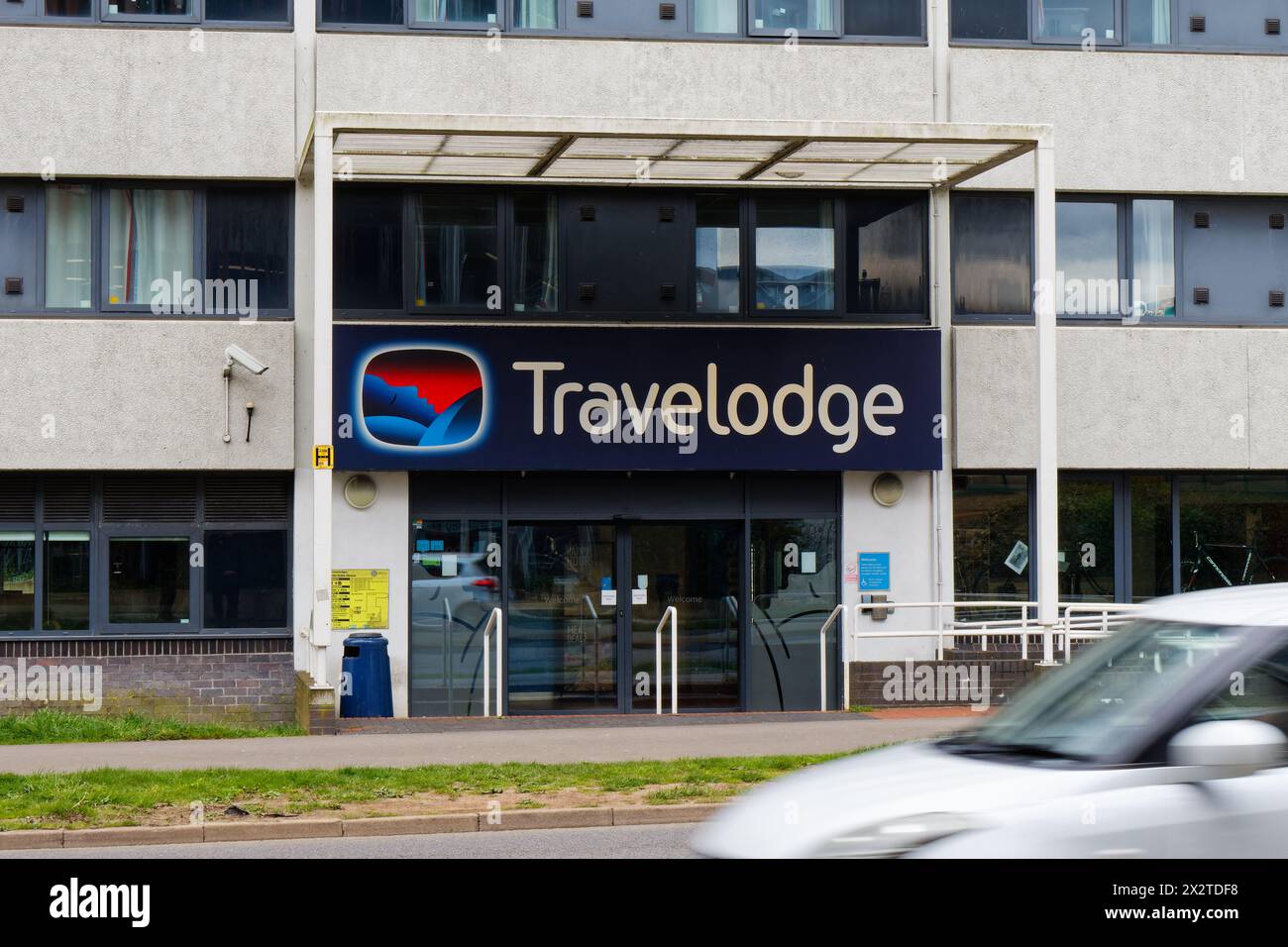 Travelodge Swindon Central's signage and entrance with passing car in ...