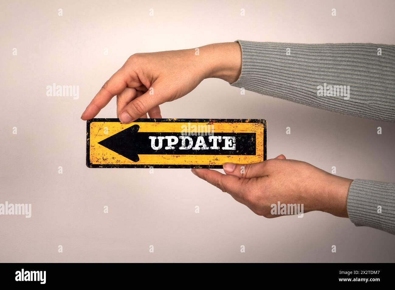 Update Concept. Pointing arrow with text in hands on white background ...