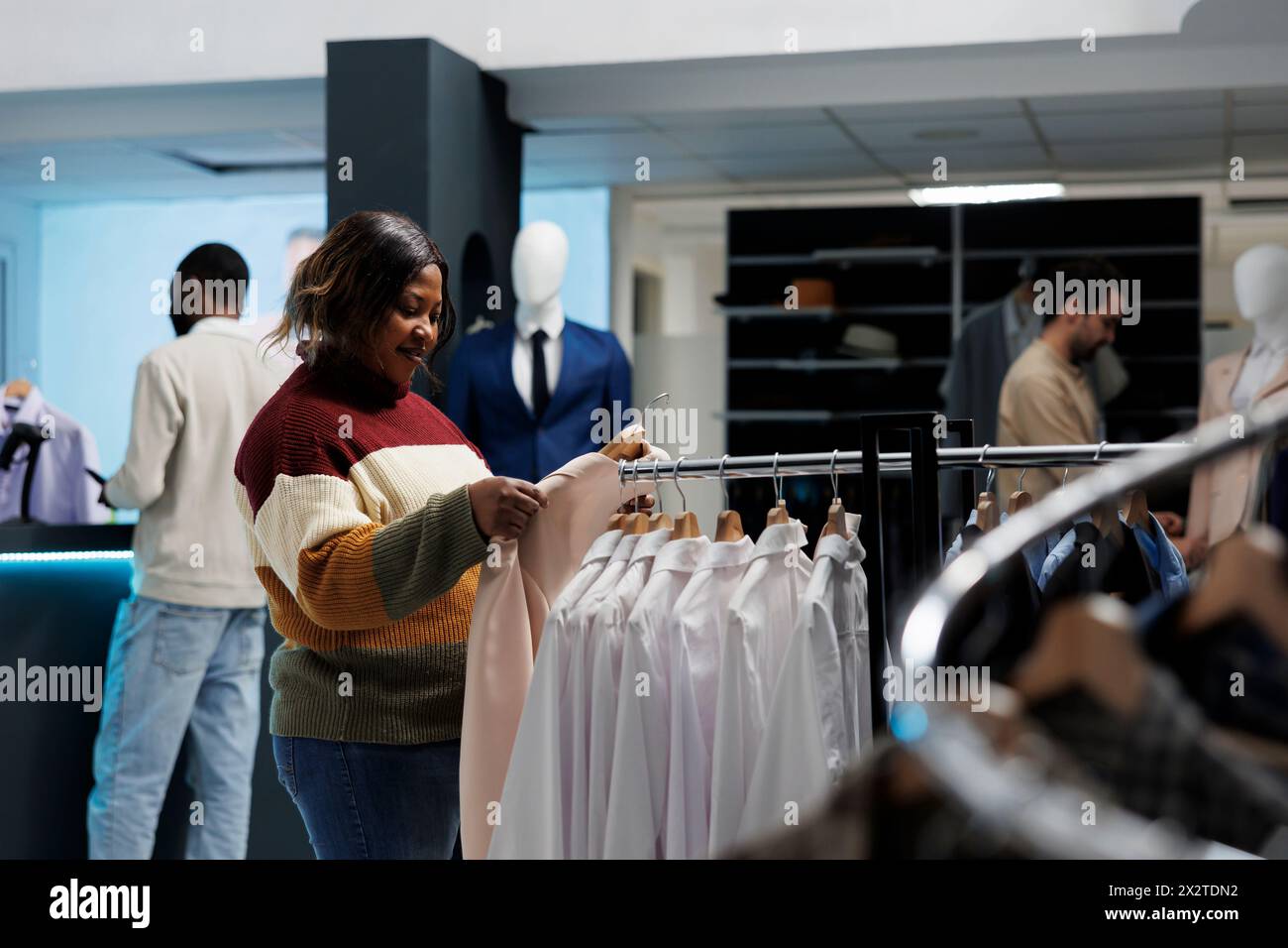 African american woman checking hanger hi-res stock photography and ...