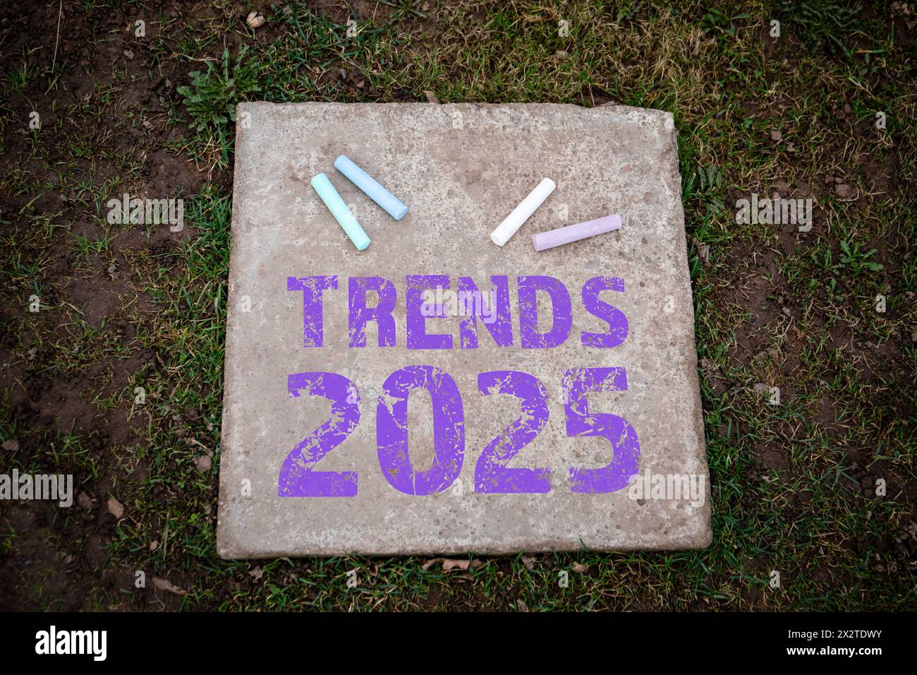 TRENDS 2025. Colored pieces of chalk on a concrete pavement slab Stock ...